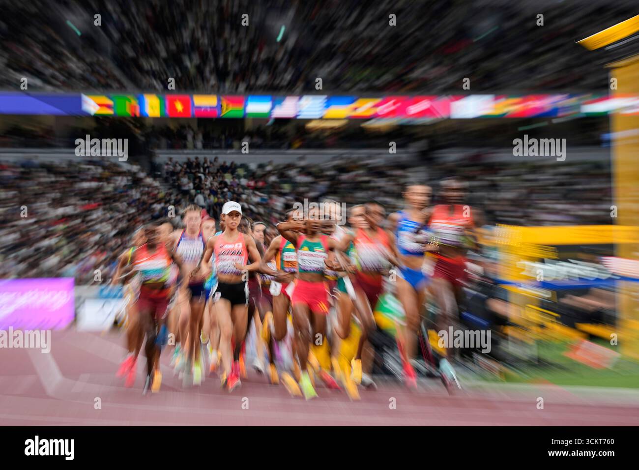 Athletes race during the women's 10,000 meters final at the World ...