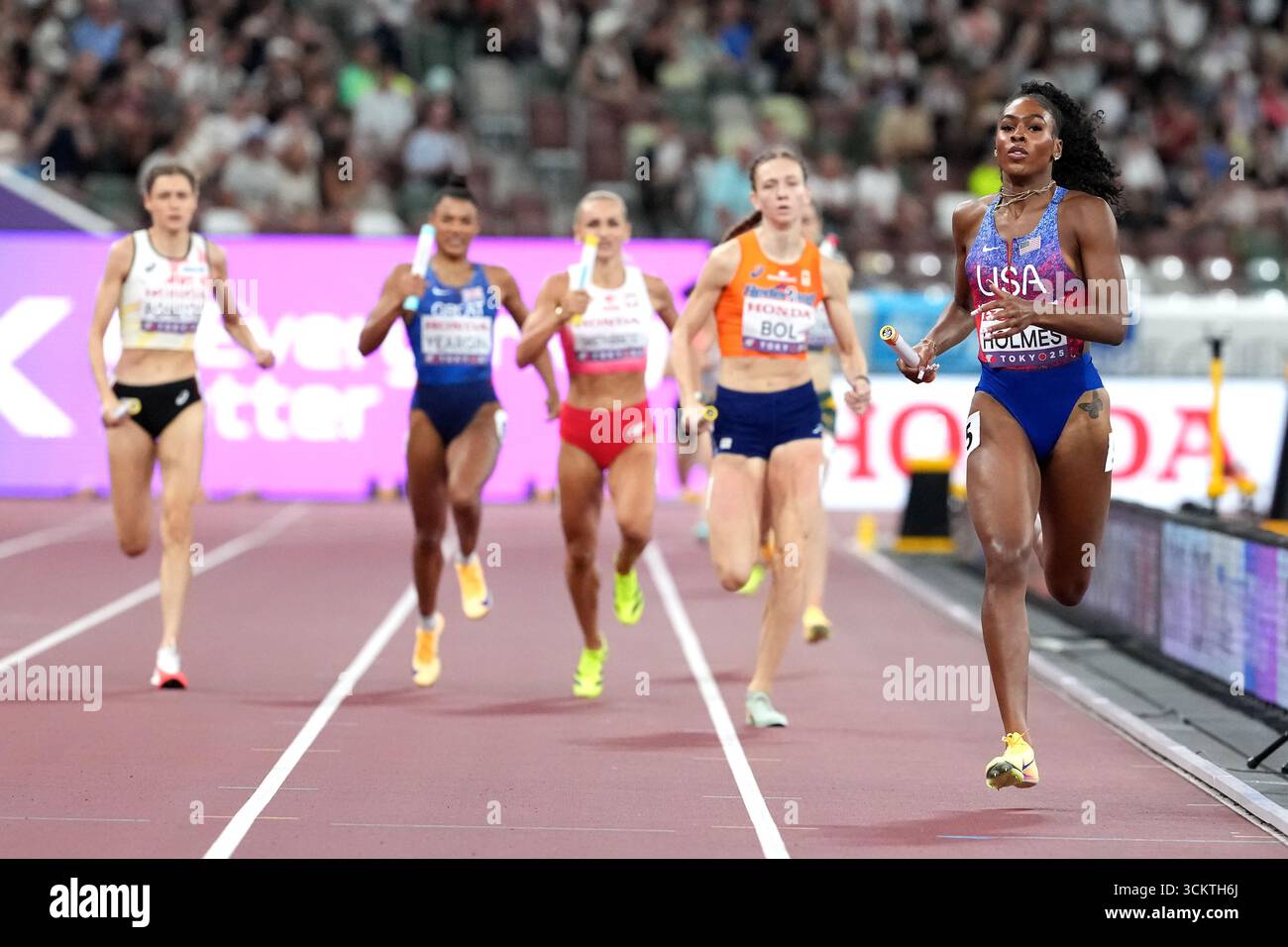 Alexis Holmes of USA (right) on her way to finishing first in the 4x400 ...