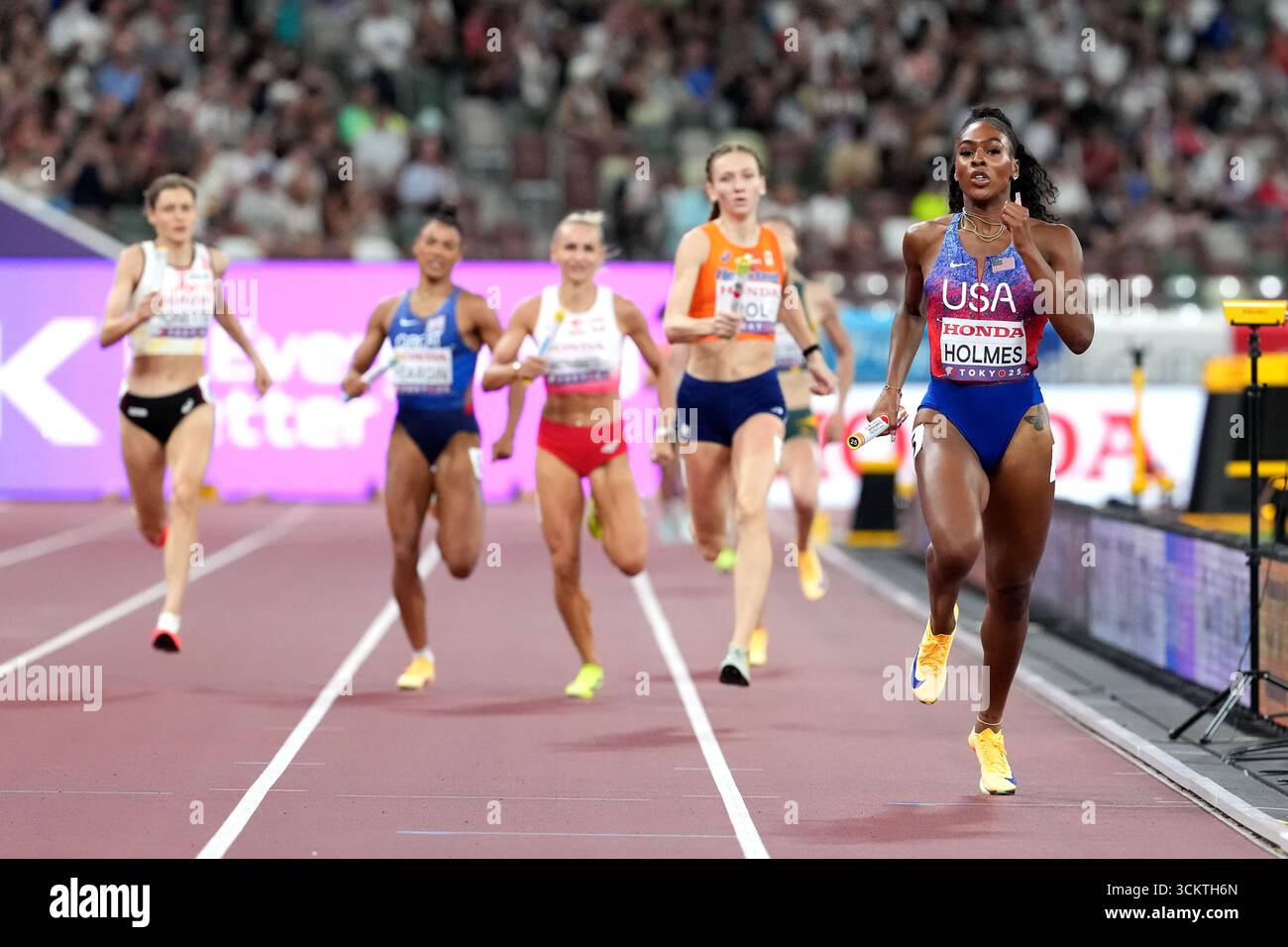 Alexis Holmes of USA (right) on her way to finishing first in the 4x400 ...