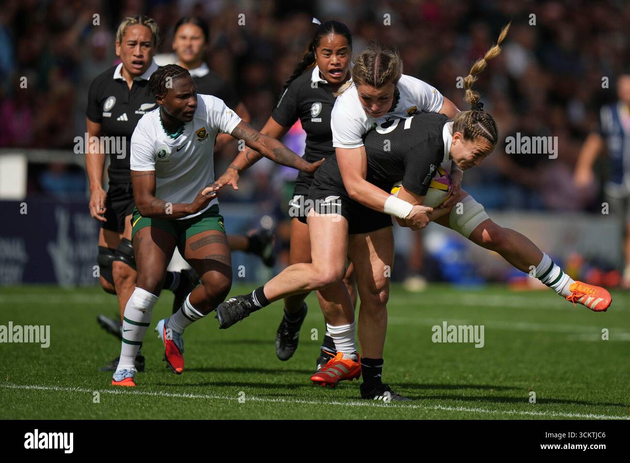 New Zealand's Renee Holmes, front, is tackled by South Africa's Catha ...