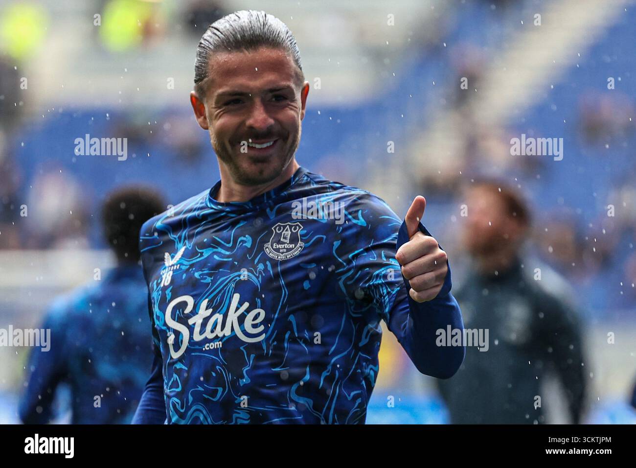 Jack Grealish of Everton warming up and gives a smile and thumbs up to ...