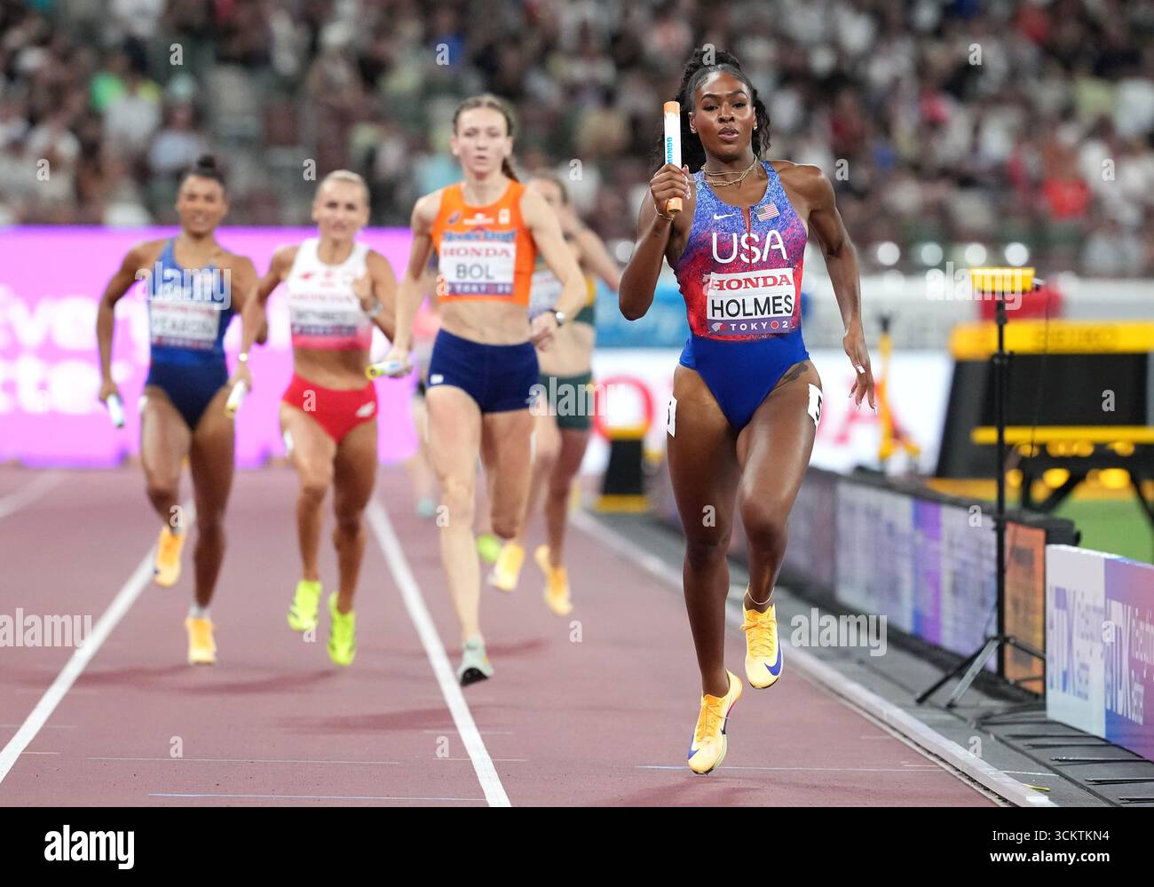 Alexis Holmes of USA (right) on her way to finishing first in the 4x400 ...
