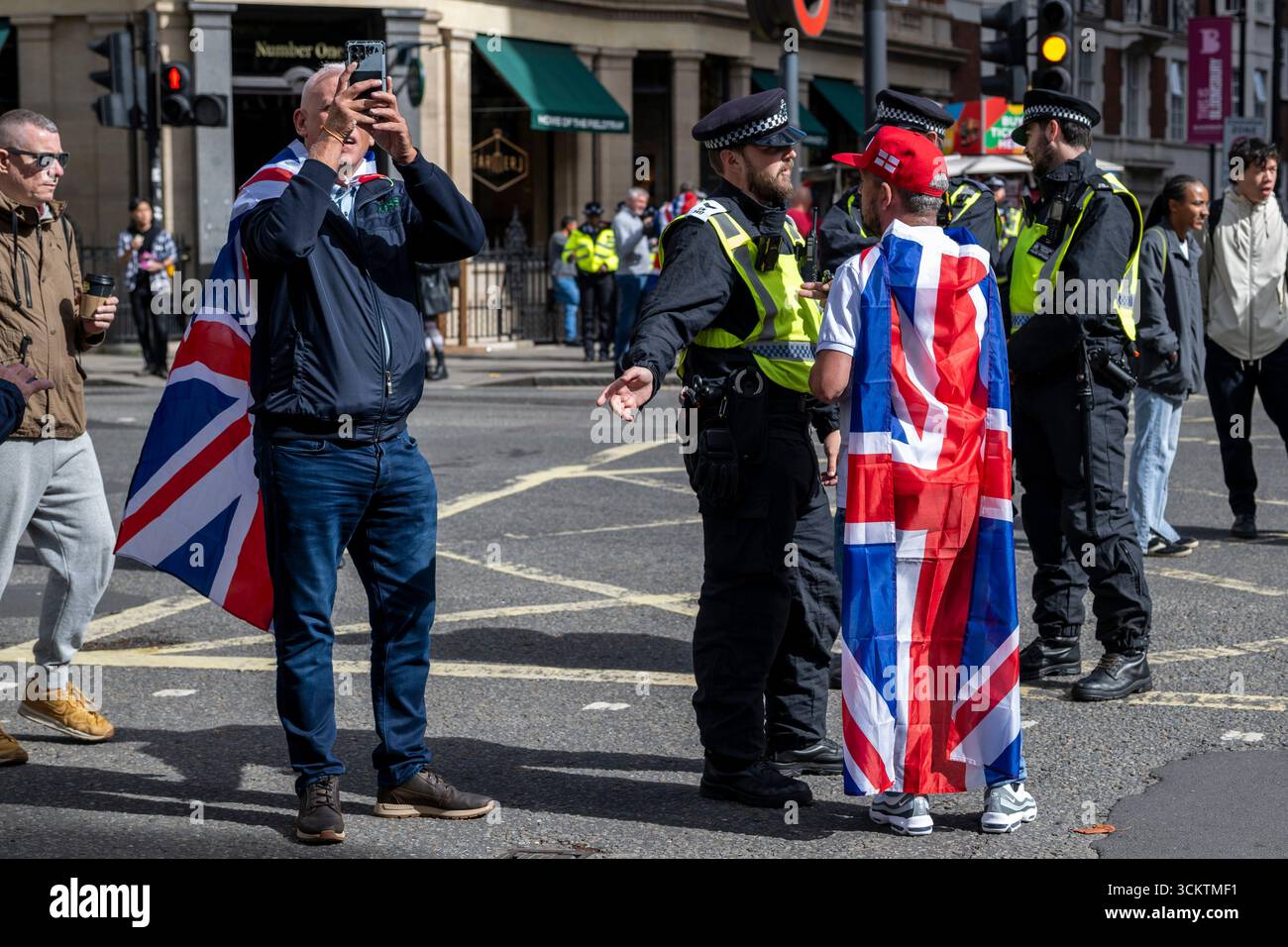 London, UK. 13 September 2025. A man wearing a Union Jack flag is ...
