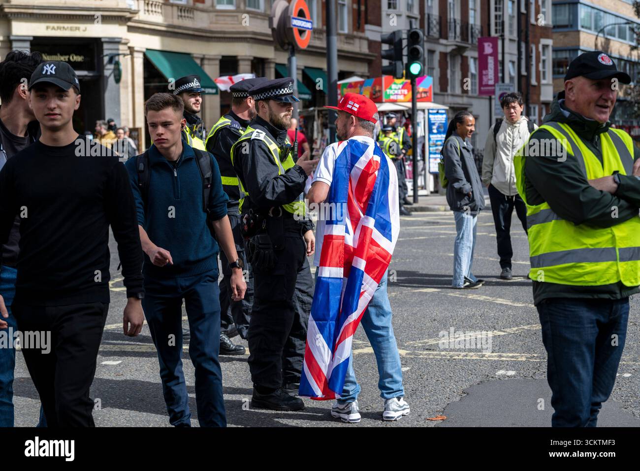 London, UK. 13 September 2025. A man wearing a Union Jack flag is ...