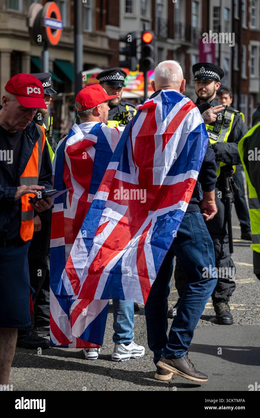 London, UK. 13 September 2025. Men wearing a Union Jack flags are ...