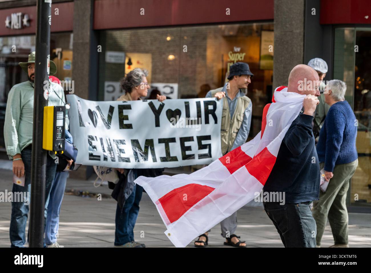 London, UK. 13 September 2025. A man wearing an England flag passes ...