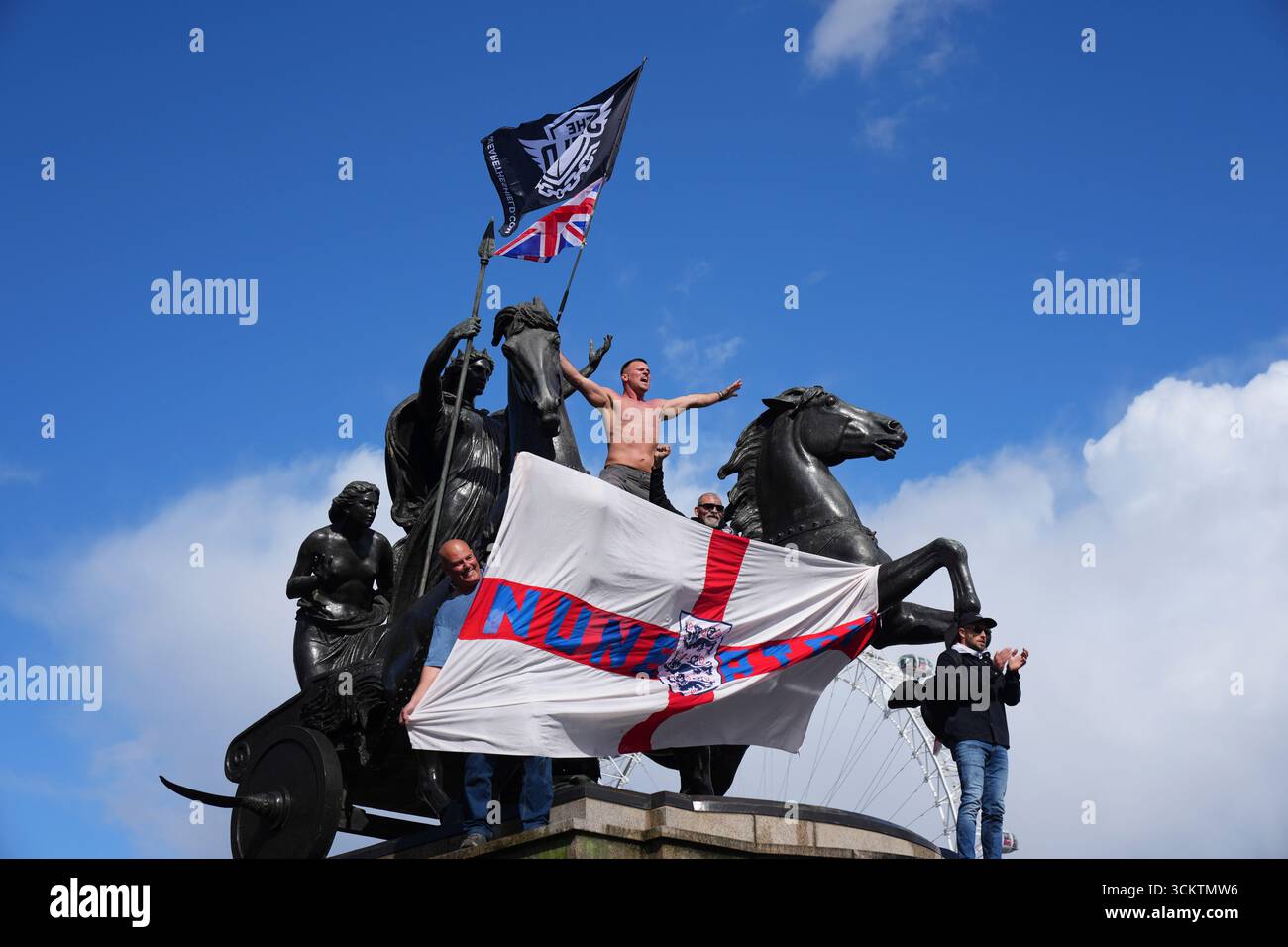 People demonstrate during the Tommy Robinson-led Unite the Kingdom ...