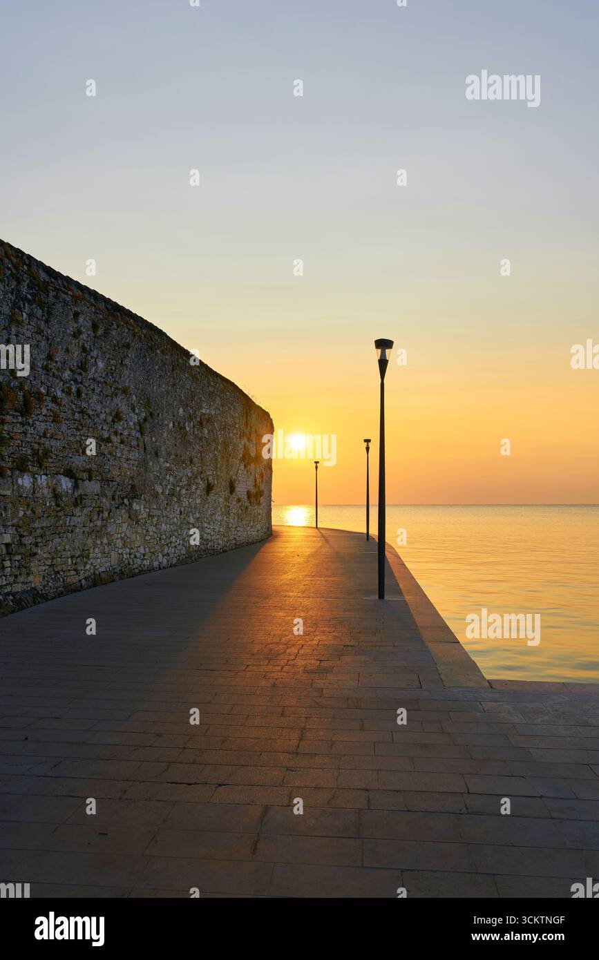 Waterfront promenade along the Adriatic Sea in Porec with lanterns and ...