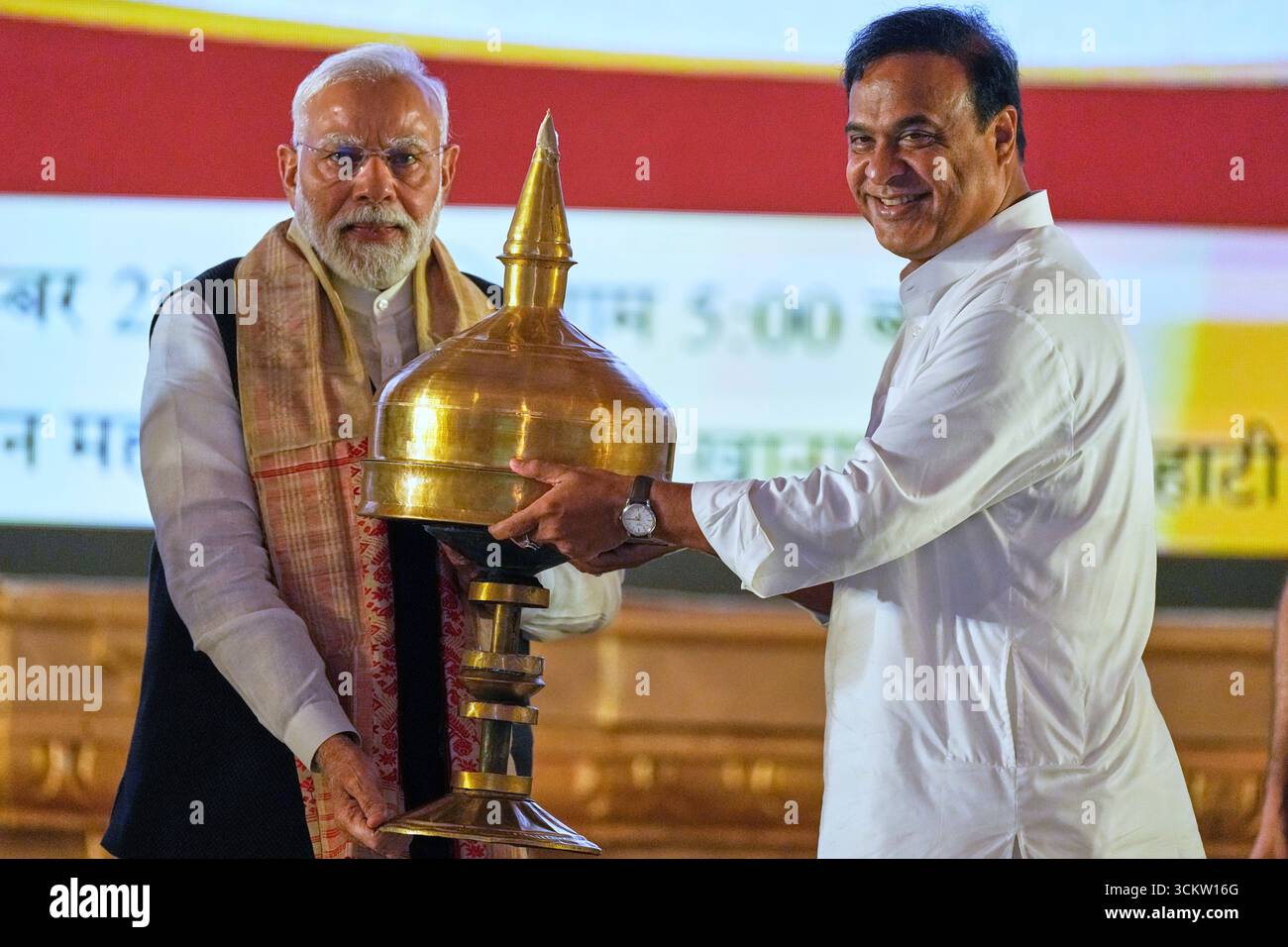 Indian Prime Minister Narendra Modi, left, receives an Assamese ...
