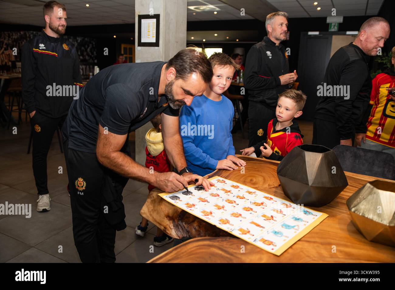 Mechelen's assistant coach Frank Magerman signs an autograph during the ...