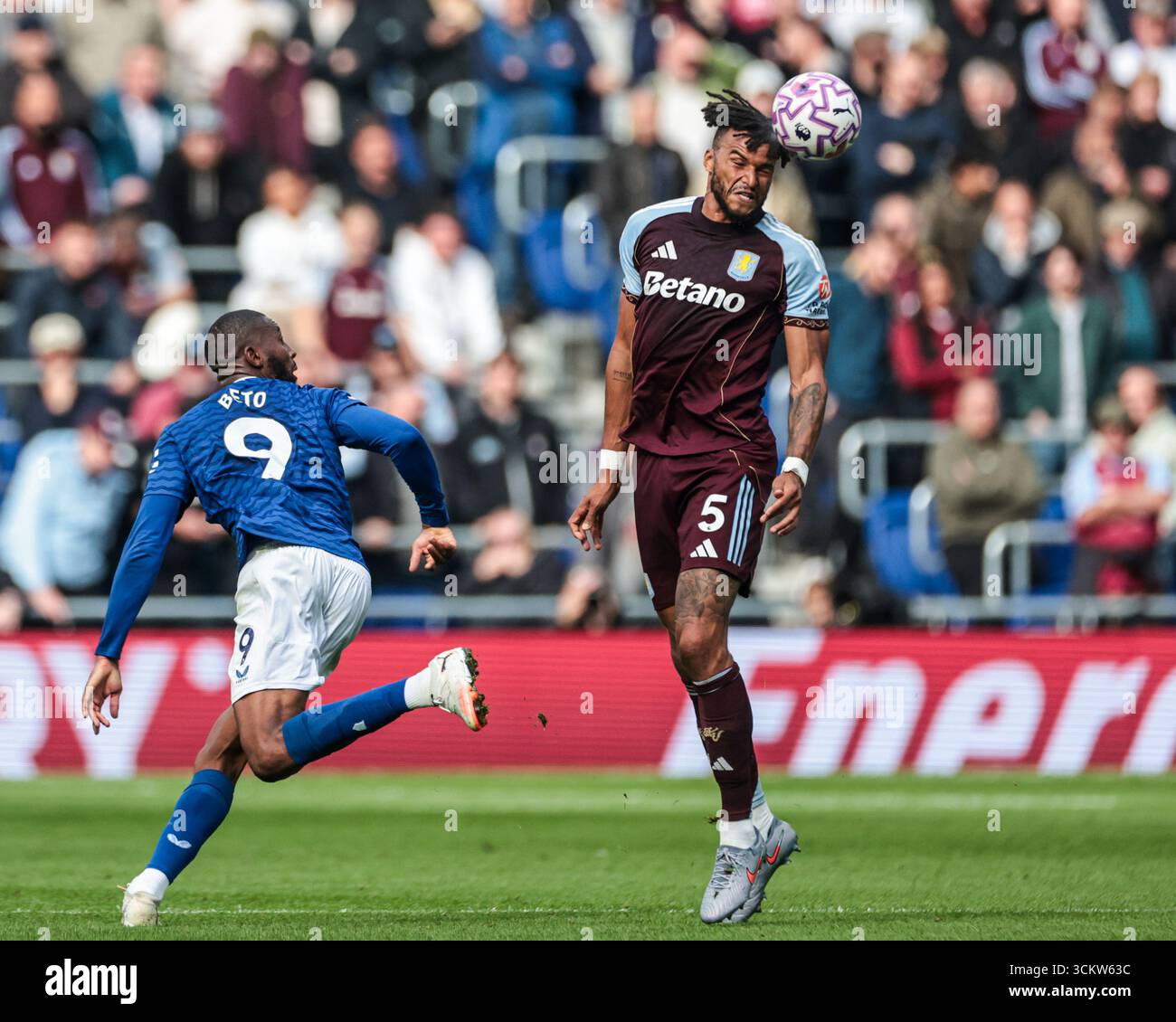 Tyrone Mings of Aston Villa heads the ball away during the Premier ...
