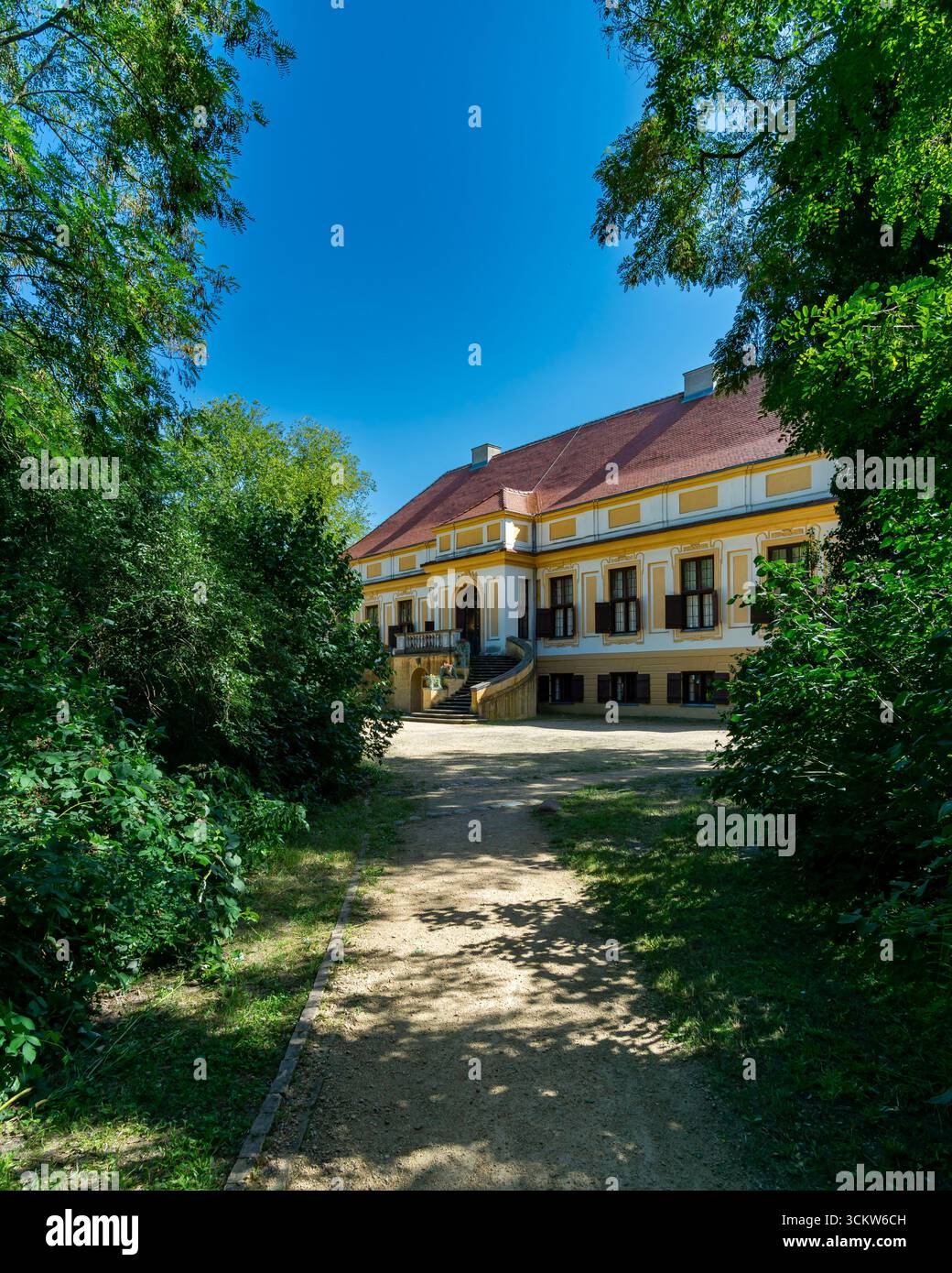 Back entrance of Caputh Palace (Schloss Caputh) surrounded by trees ...