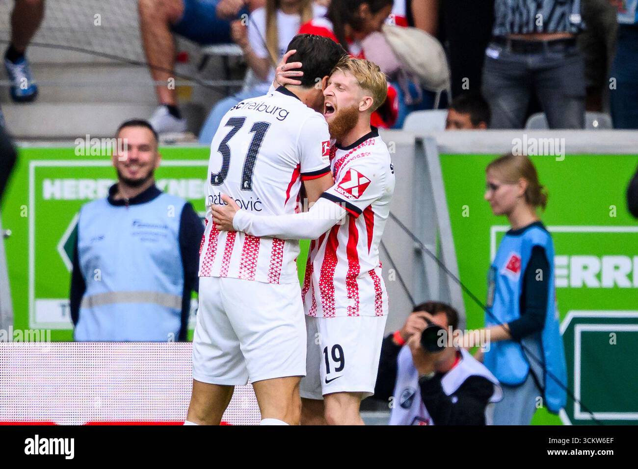 Freiburg's scorer Igor Matanovic, left, and his teammate Jan-Niklas ...