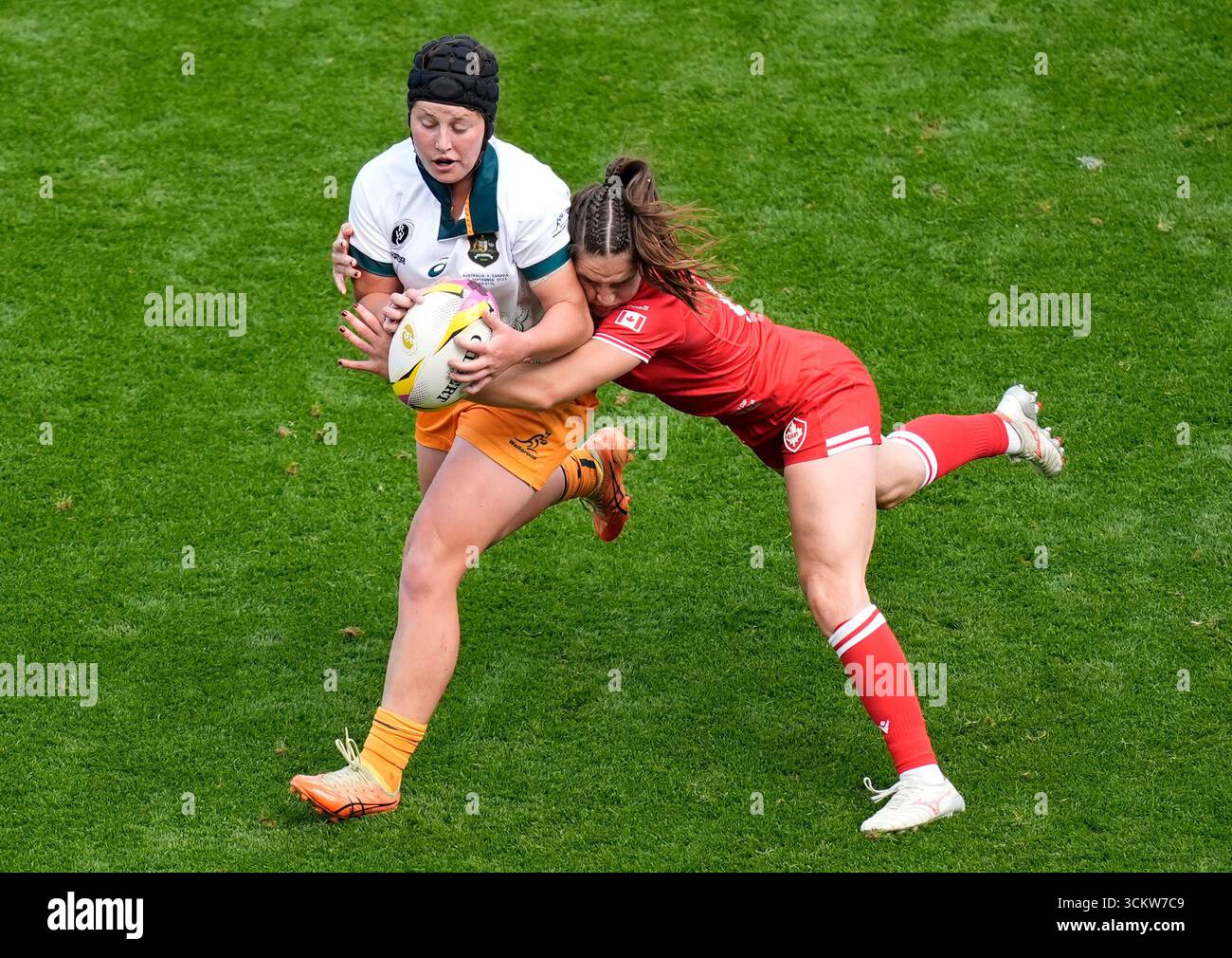 Australia's Samantha Wood (left) is tackled by Canada's Taylor Perry ...