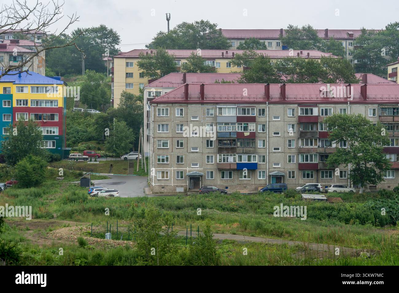 Soviet-era apartment block and sloping street in Korsakov, Sakhalin ...