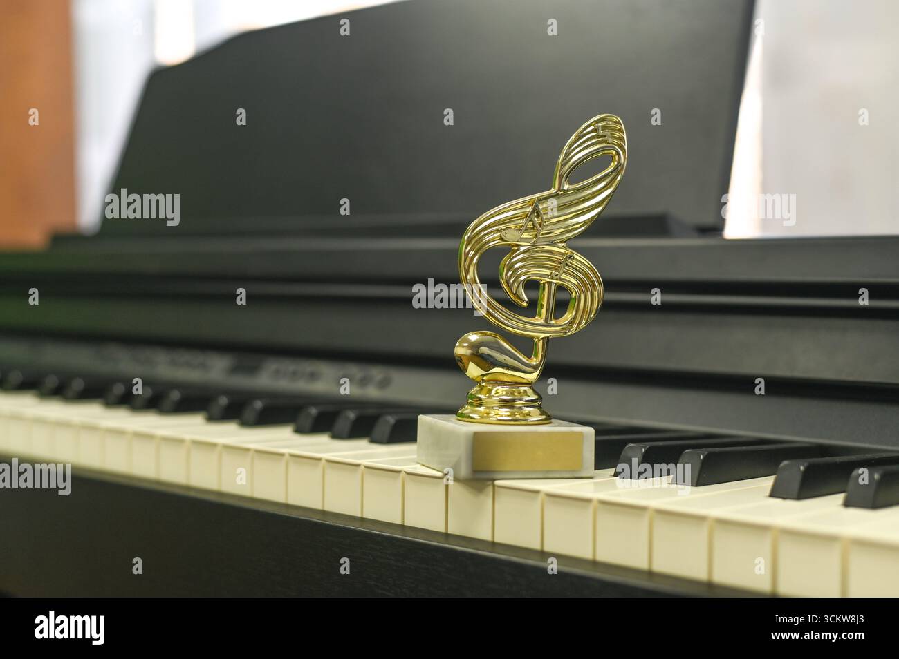 Award statue in shape of treble clef on sleek piano, representing ...