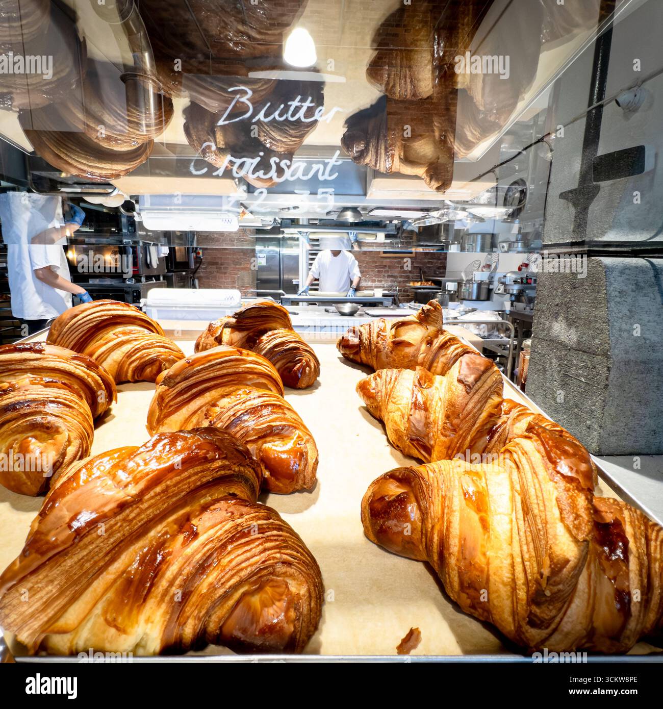 Croissants on display in a bakery. A croissant is a French Viennoiserie ...