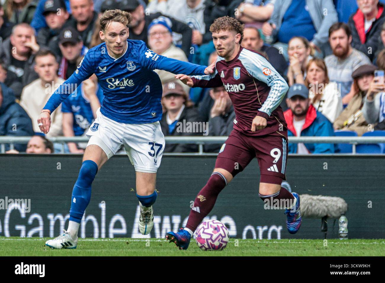 Harvey Elliott of Aston Villa dribbles past James Garner of Everton ...