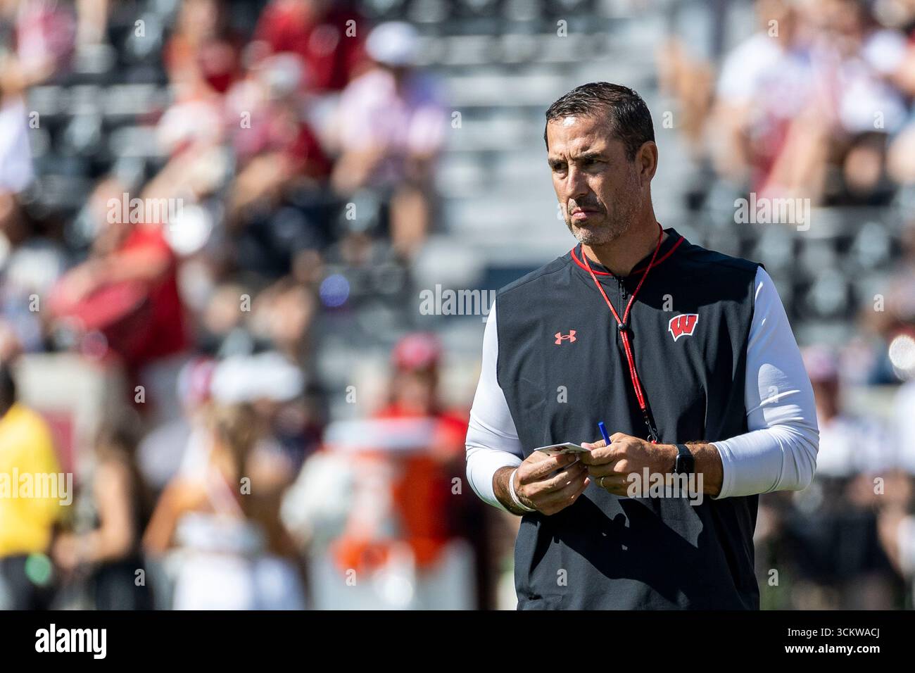 Wisconsin head coach Luke Fickell walks the field during warmups before ...