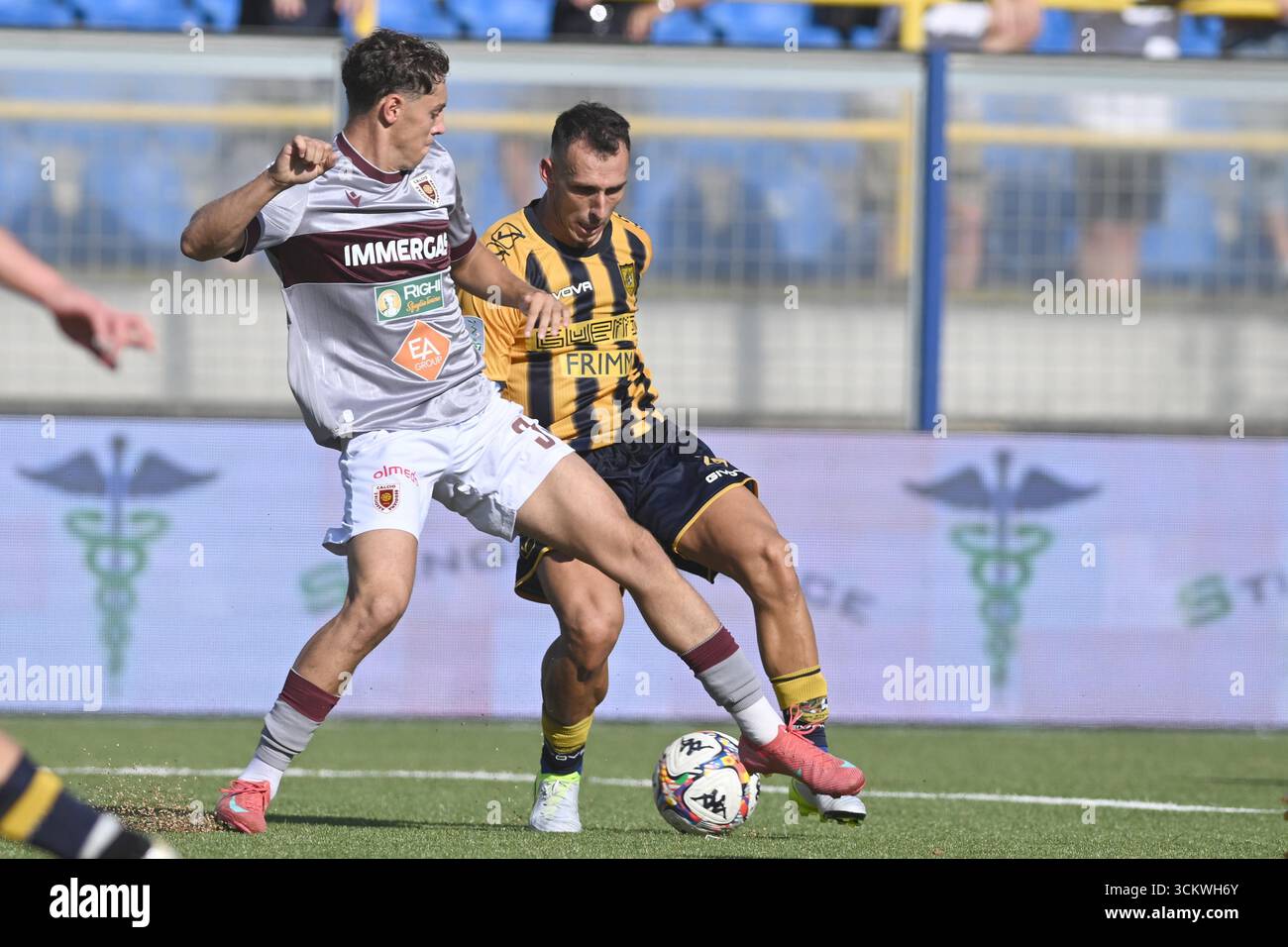Andrea Bozzolan of AC Reggiana 1919 competes for the ball with Lorenzo ...