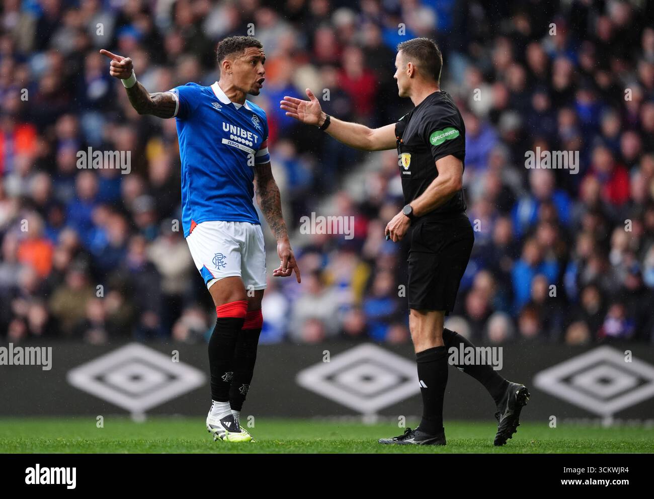 Rangers' James Tavernier (left) reacts to a decision by referee Steven ...