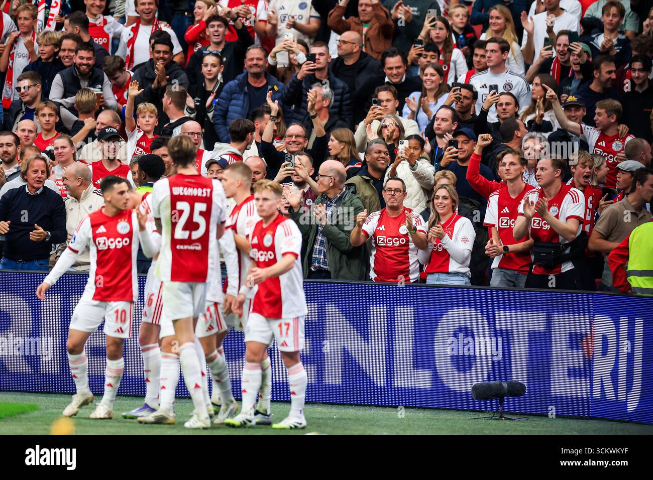 AMSTERDAM - Ajax fans celebrate Mika Godts of Ajax's 3-1 goal during the Dutch Eredivisie match ...