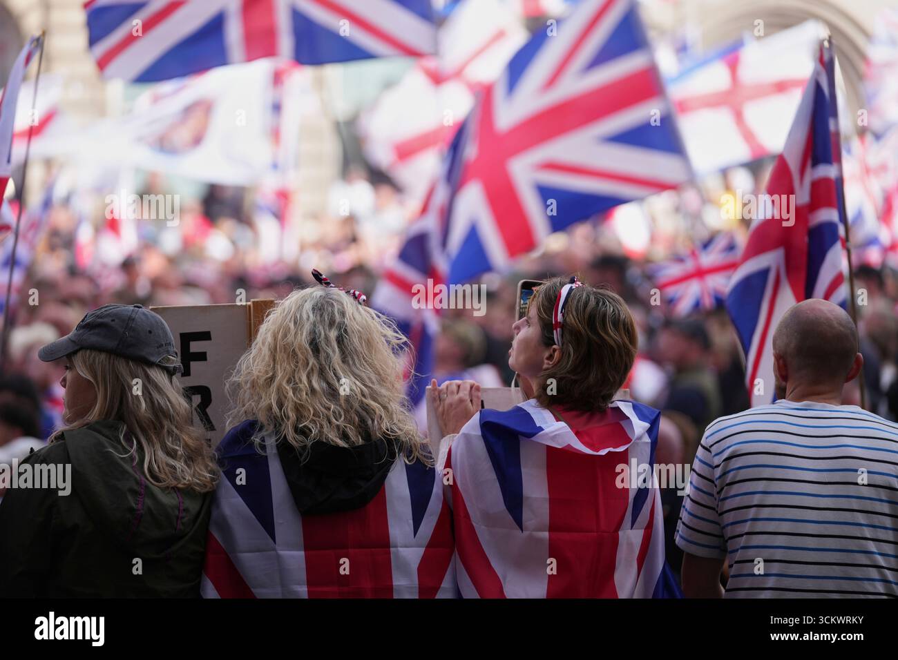People demonstrate during the Tommy Robinson-led Unite the Kingdom ...