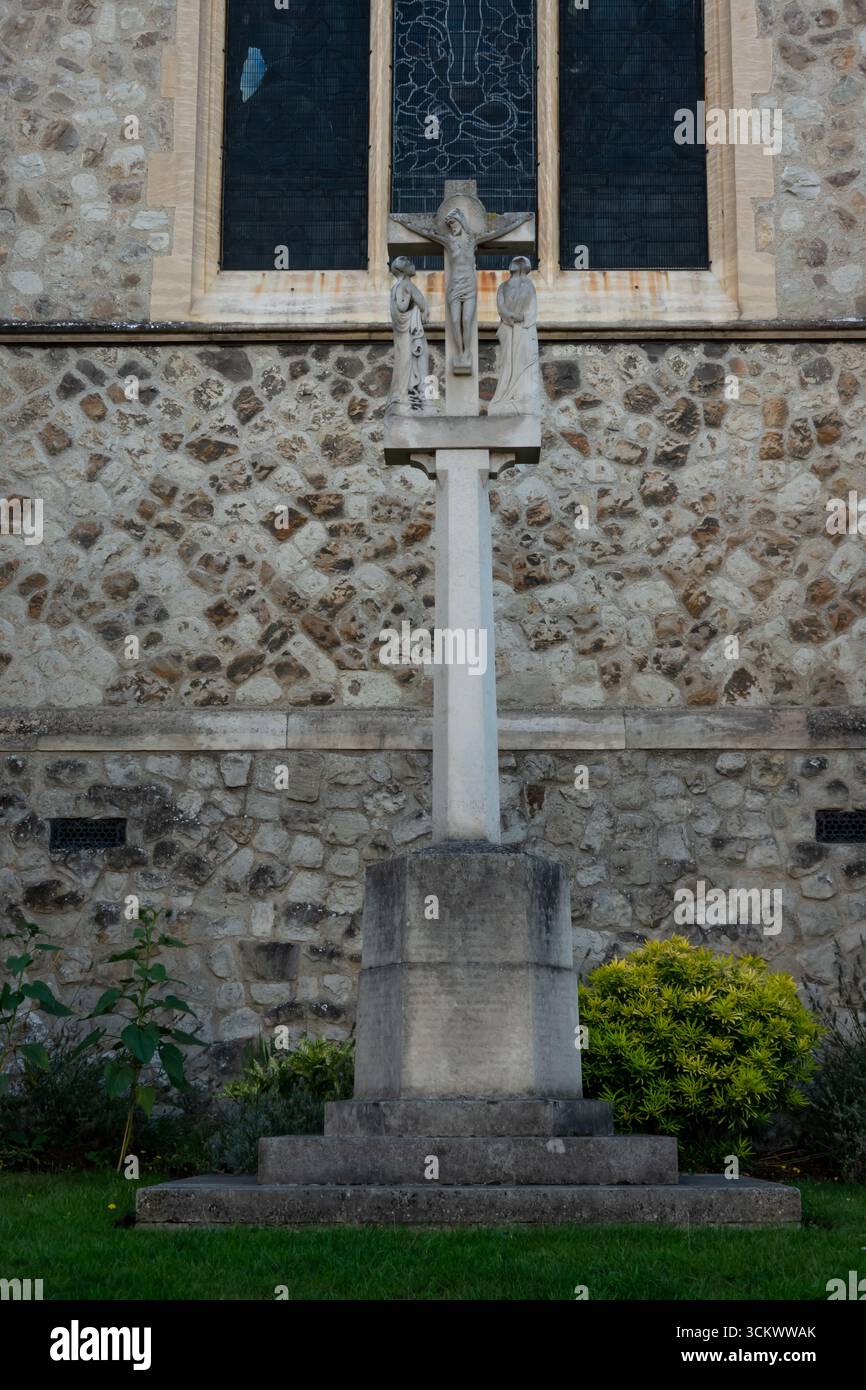 A stone cross monument stands in front of Holy Trinity Church in ...