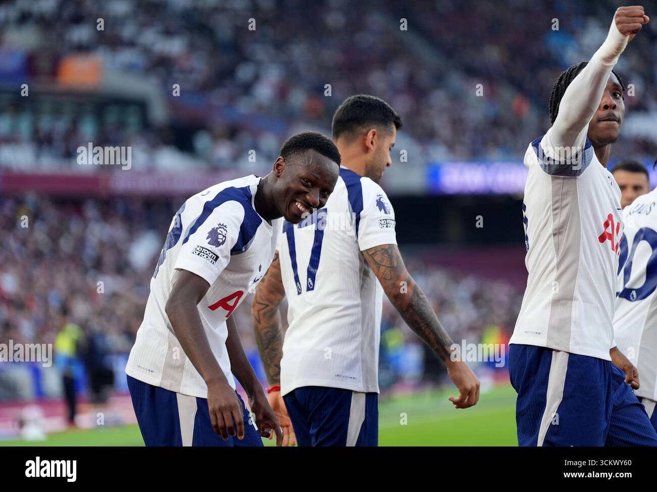 Tottenham Hotspur's Pape Matar Sarr (left) celebrates after scoring his ...