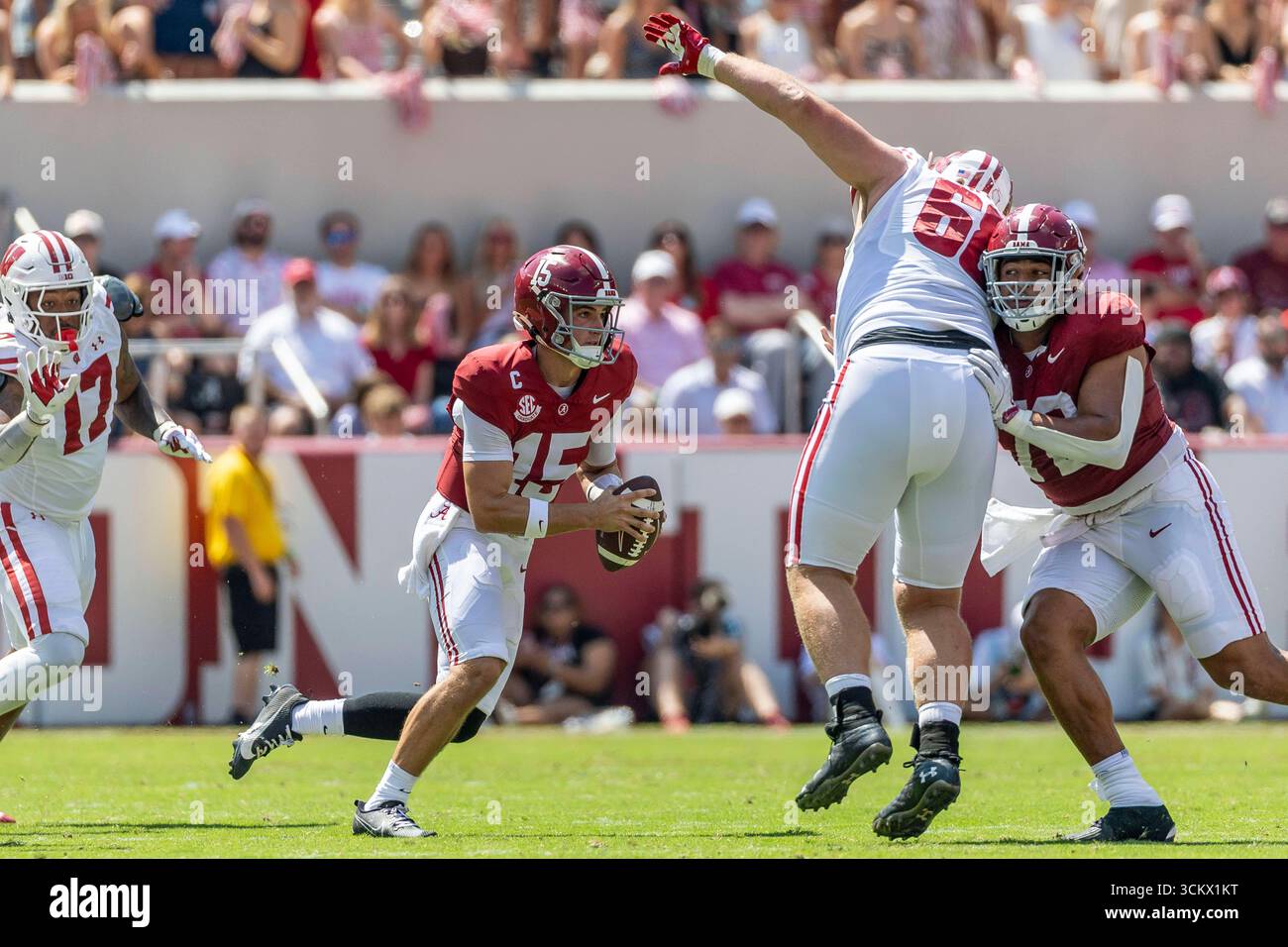 Alabama quarterback Ty Simpson (15) works to find a running lane with ...