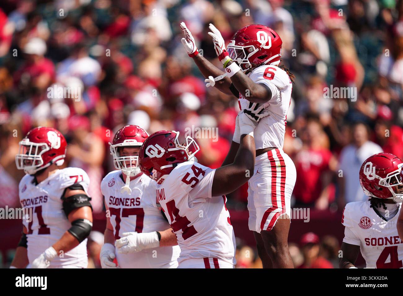Oklahoma running back Tory Blaylock (6) celebrates with Febechi Nwaiwu ...
