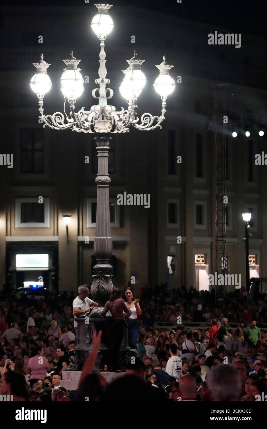 Spectators watch during a concert in St. Peter's Square for the ...