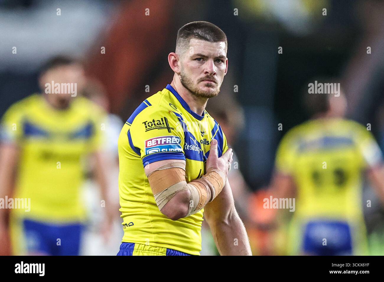 Danny Walker of Warrington Wolves pats his badge to the fans during the ...