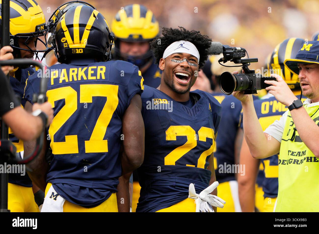 Michigan running back Justice Haynes, right, greets Jasper Parker on ...