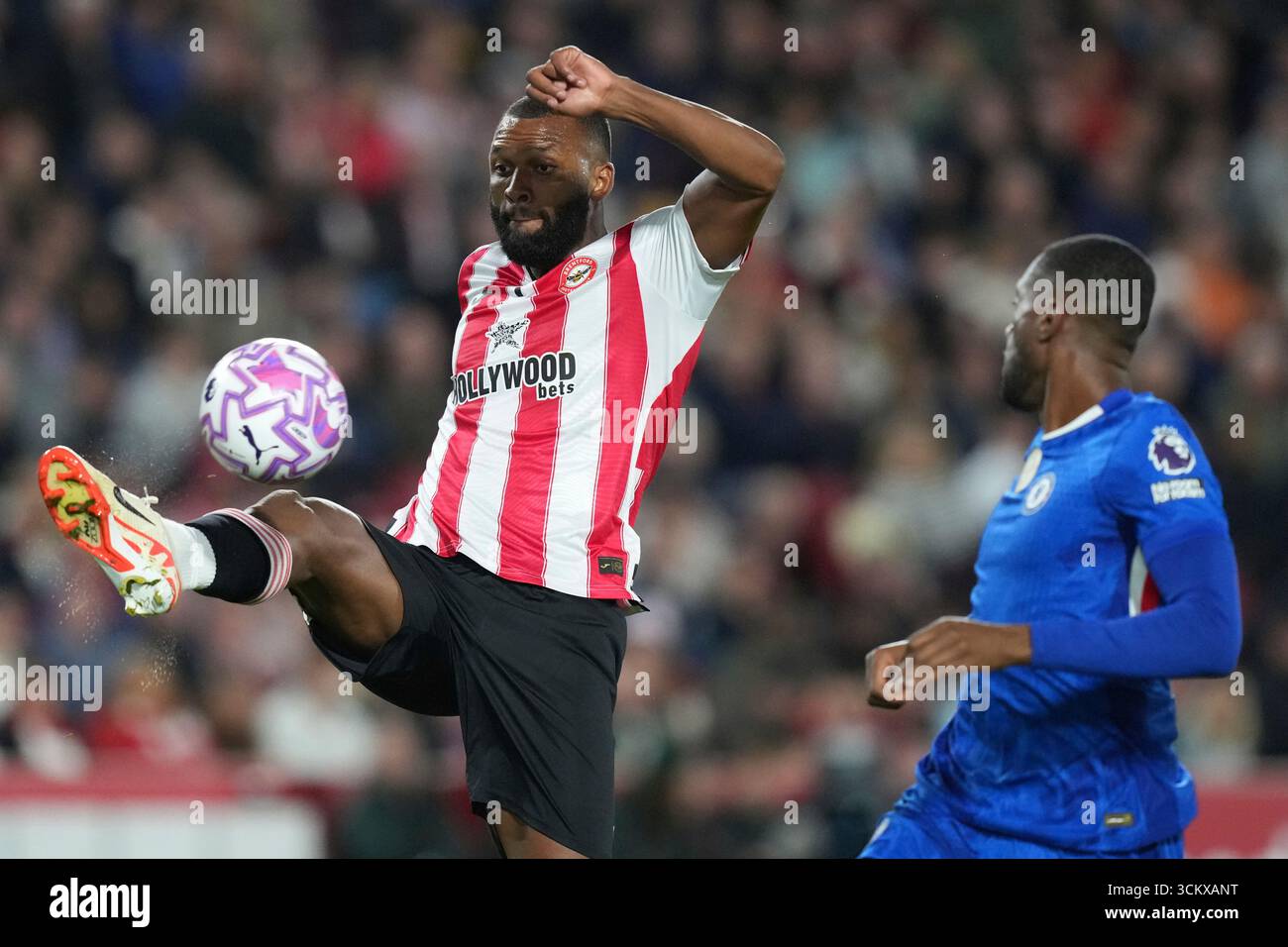 Brentford's Igor Thiago passes the ball over Chelsea's Tosin Adarabioyo ...