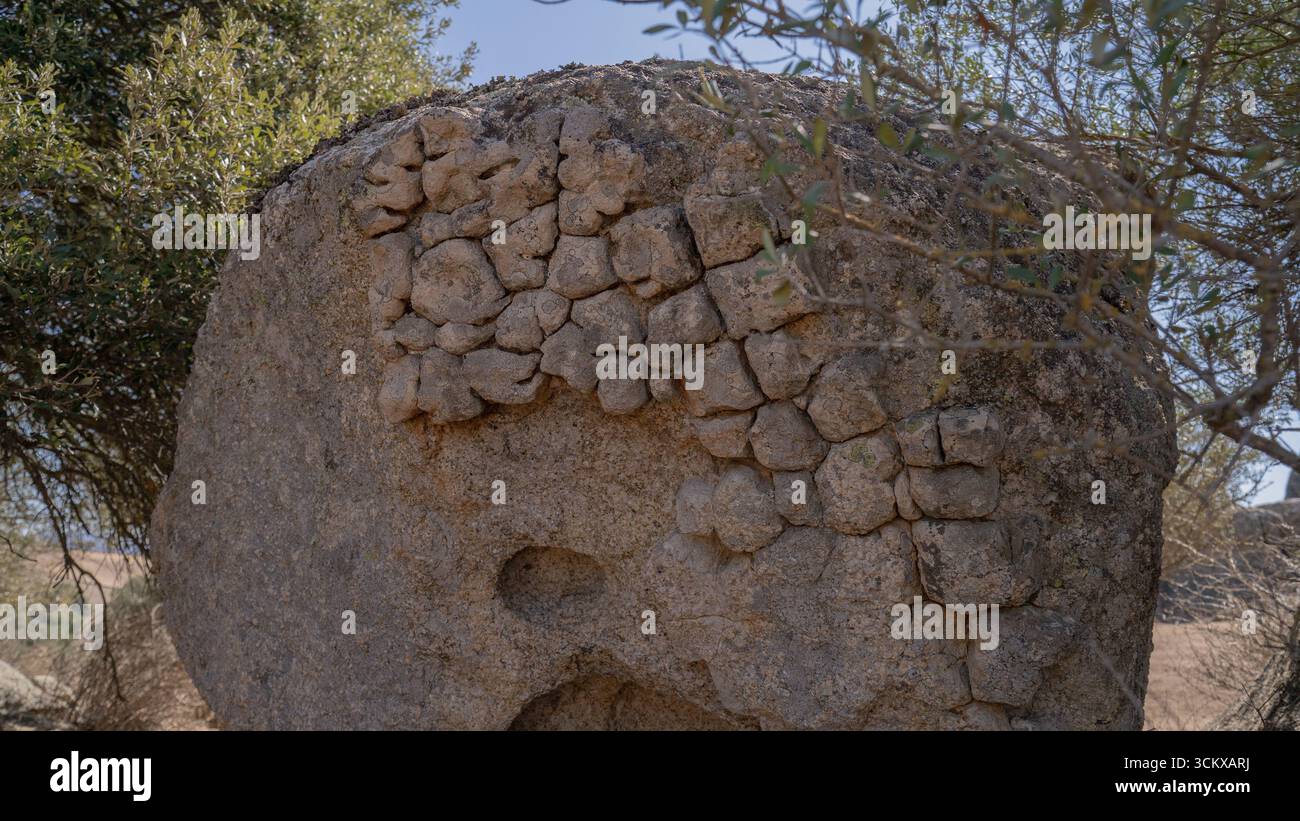 Prehistoric chamber tomb carved into rock with natural arch-shaped ...