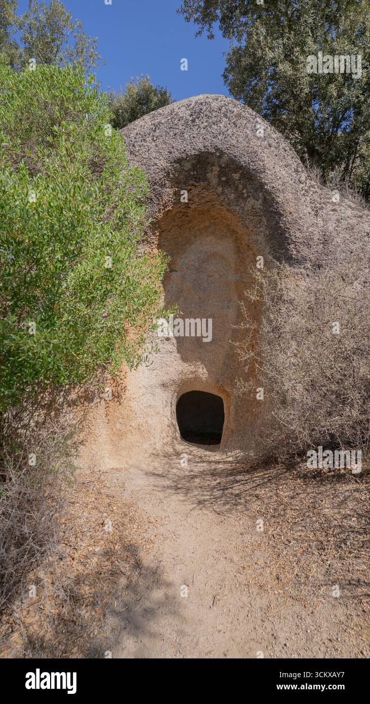 Prehistoric chamber tomb carved into rock with natural arch-shaped ...