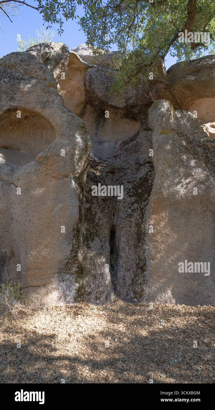 Prehistoric chamber tomb carved into rock with natural arch-shaped ...
