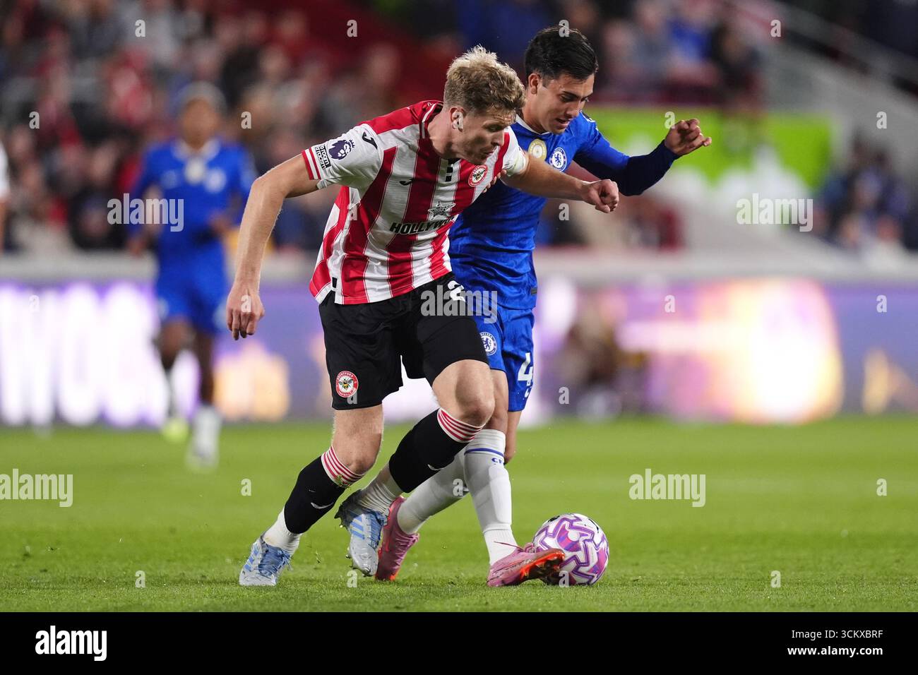 Brentford's Nathan Collins (left) and Chelsea's Facundo Buonanotte battle for the ball during ...