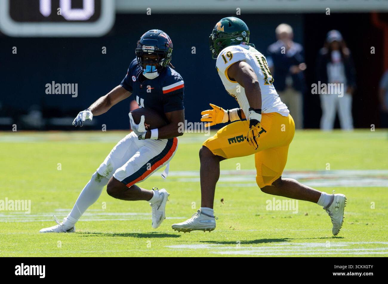 Virginia wide receiver Trell Harris (11) tries to evade William & Mary ...