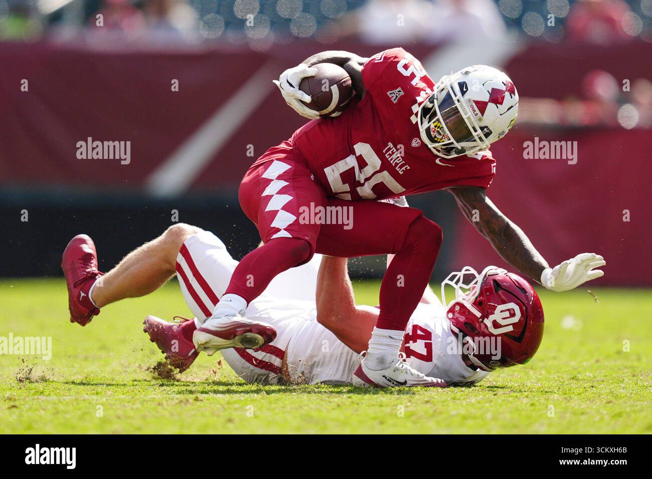 Temple running back Terrez Worthy, top, is tackled by Oklahoma ...