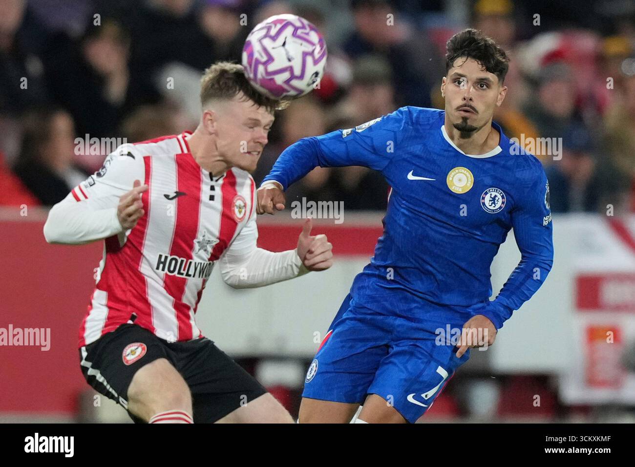 Brentford's Aaron Hickey heads the ball in front of Chelsea's Pedro ...