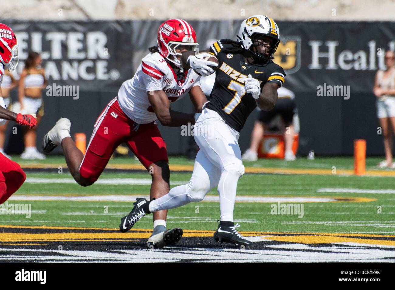 Missouri running back Marquise Davis, right, runs past Louisiana ...