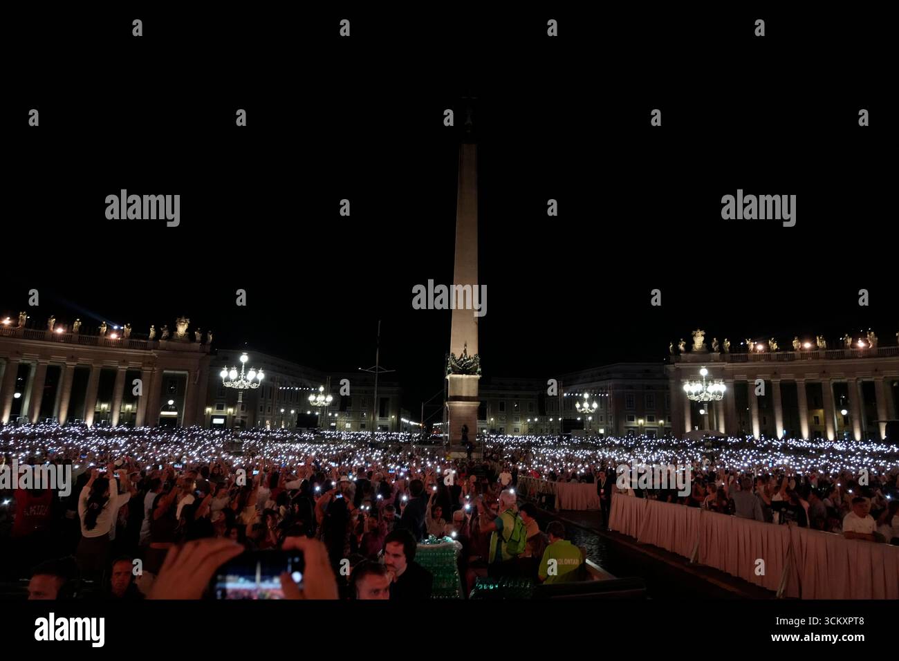 Spectators light their smartphones during a concert in St. Peter's ...
