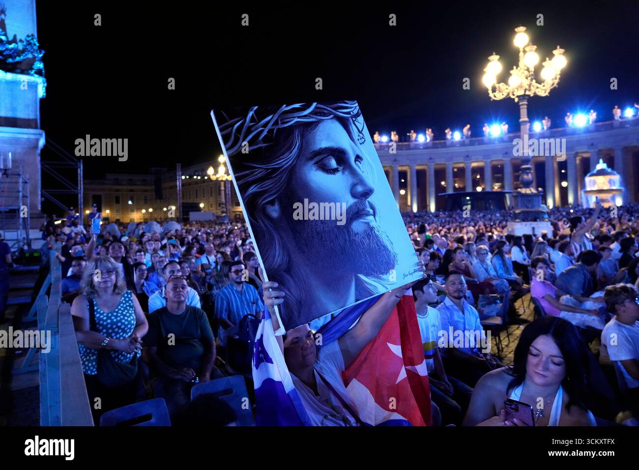 Spectators attend a concert in St. Peter's Square for the conclusion of ...