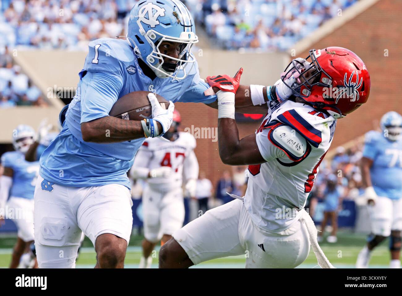 North Carolina wide receiver Jordan Shipp (1) stiff-arms Richmond ...