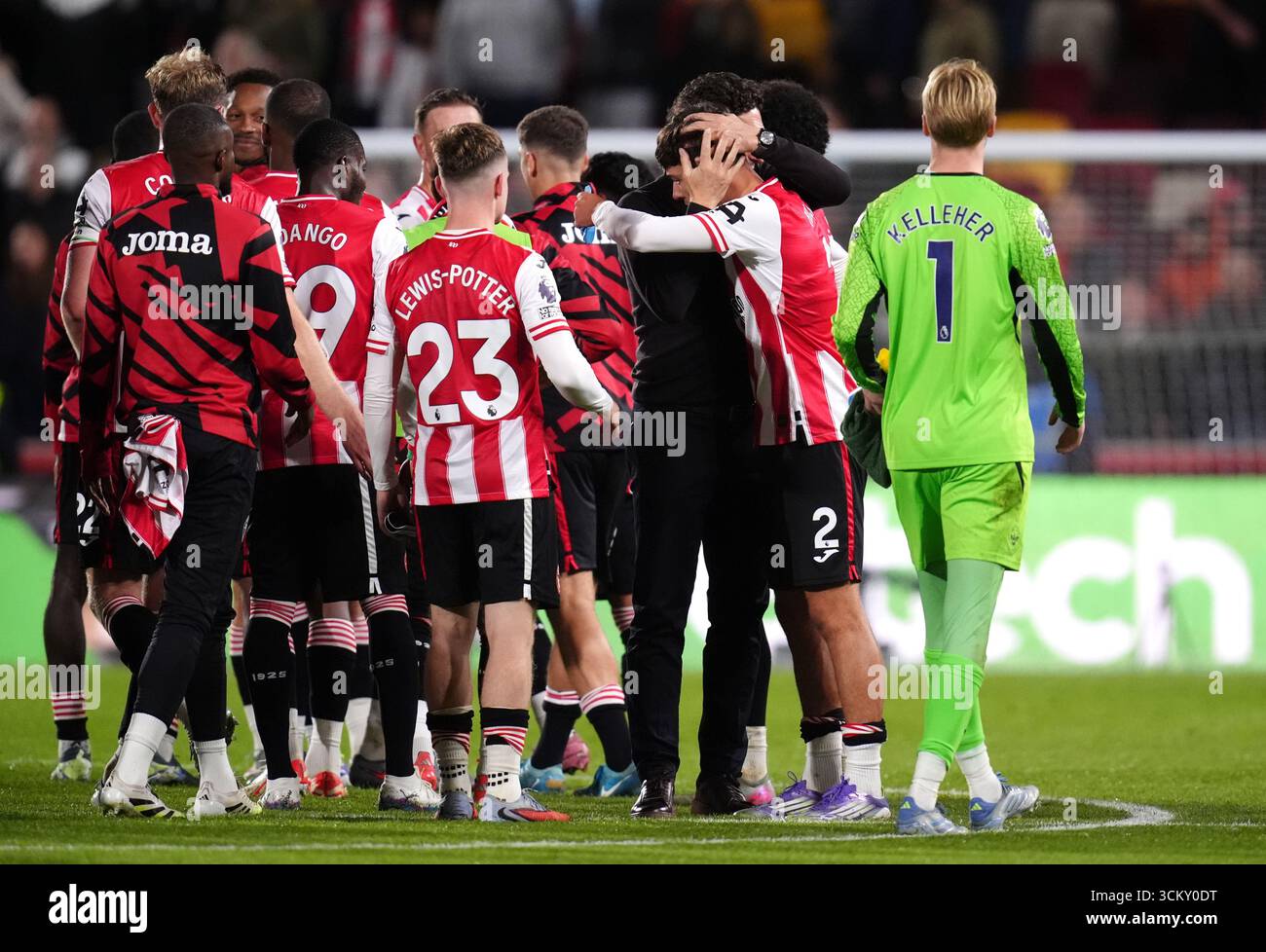 Brentford manager Keith Andrews greets Aaron Hickey following the ...