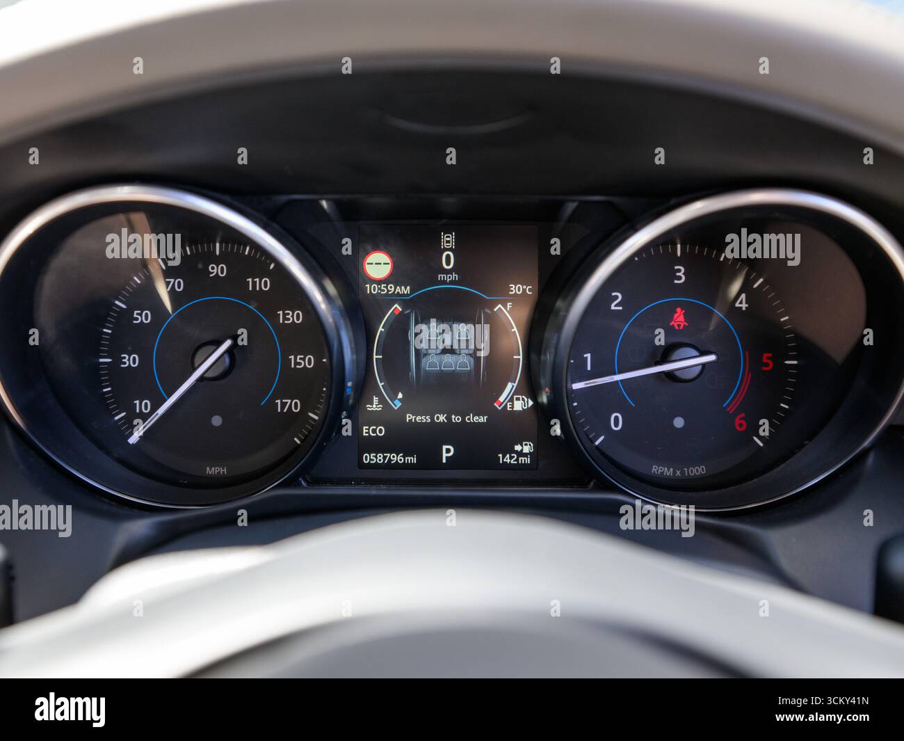 car instrument cluster featuring a speedometer and tachometer ...