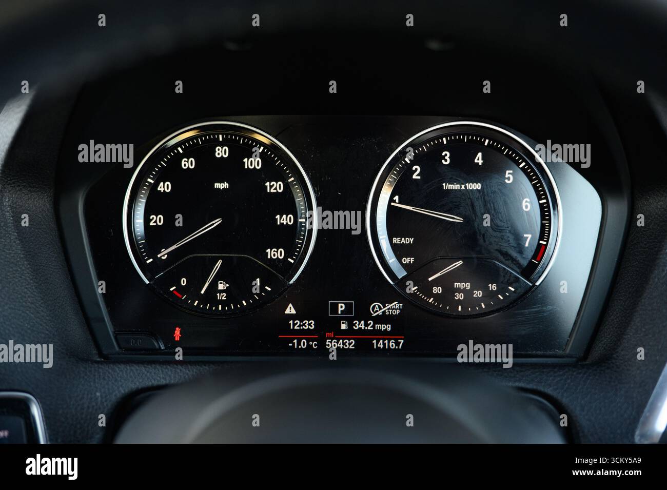 car instrument cluster featuring a speedometer and tachometer ...