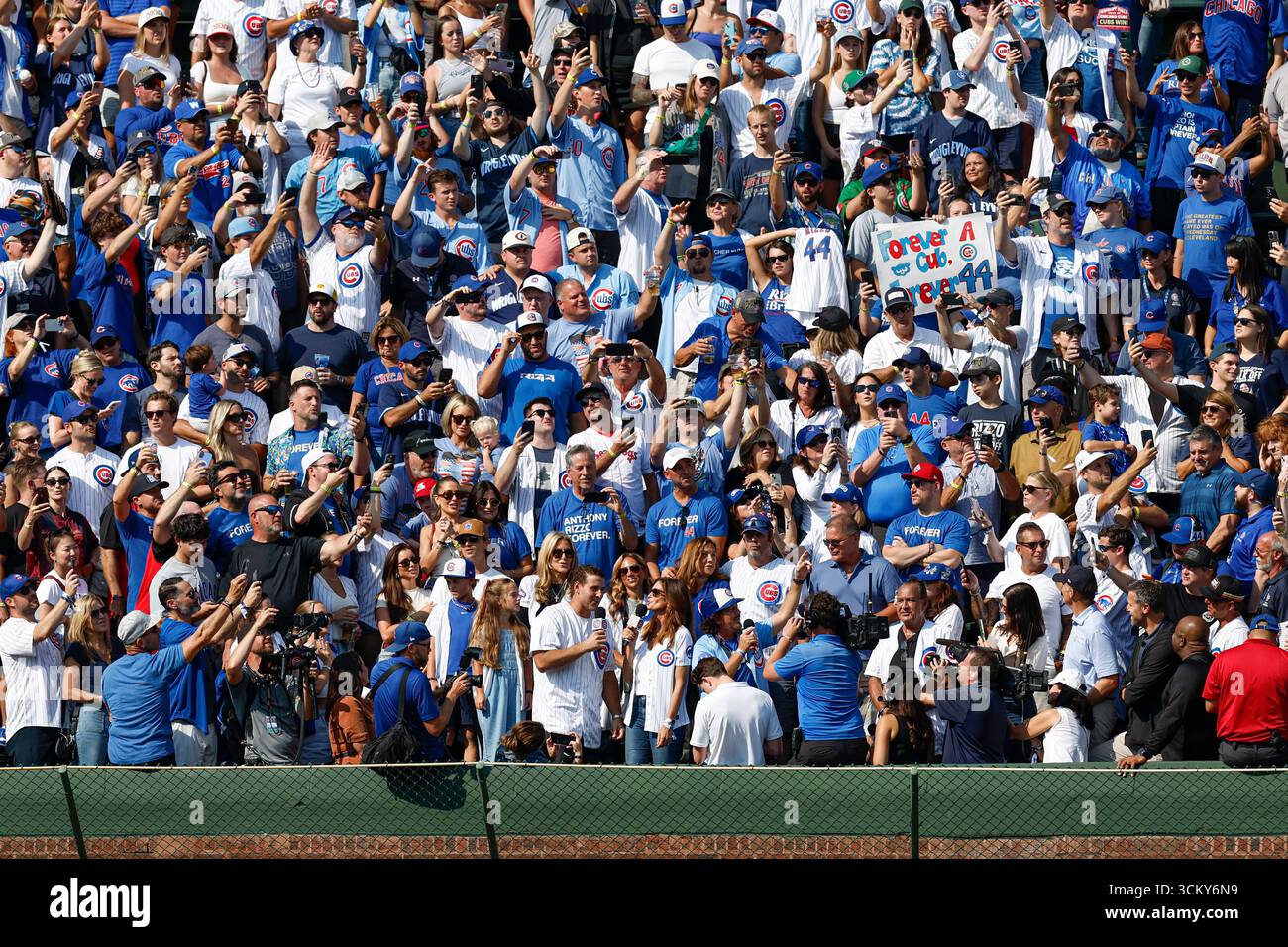 Former Chicago Cubs player Anthony Rizzo sings from the bleachers with ...